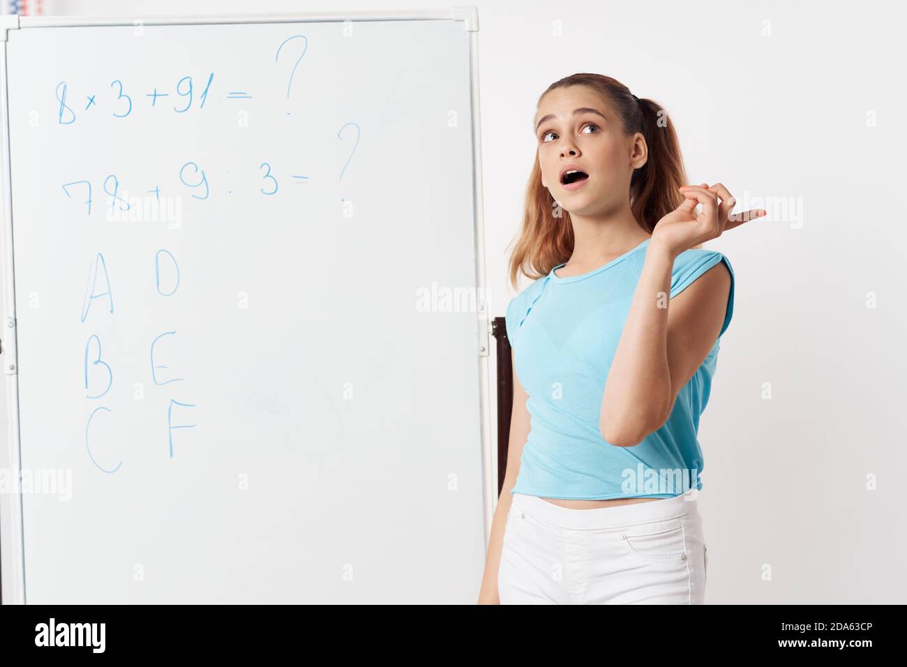 Schoolgirl near the blackboard learning the solution Stock Photo - Alamy