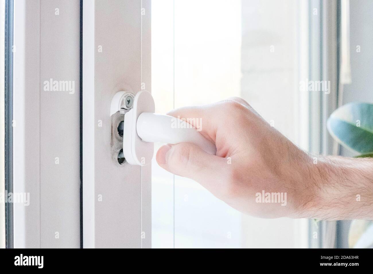 The hand opens a plastic window, the mechanism breaks Stock Photo - Alamy