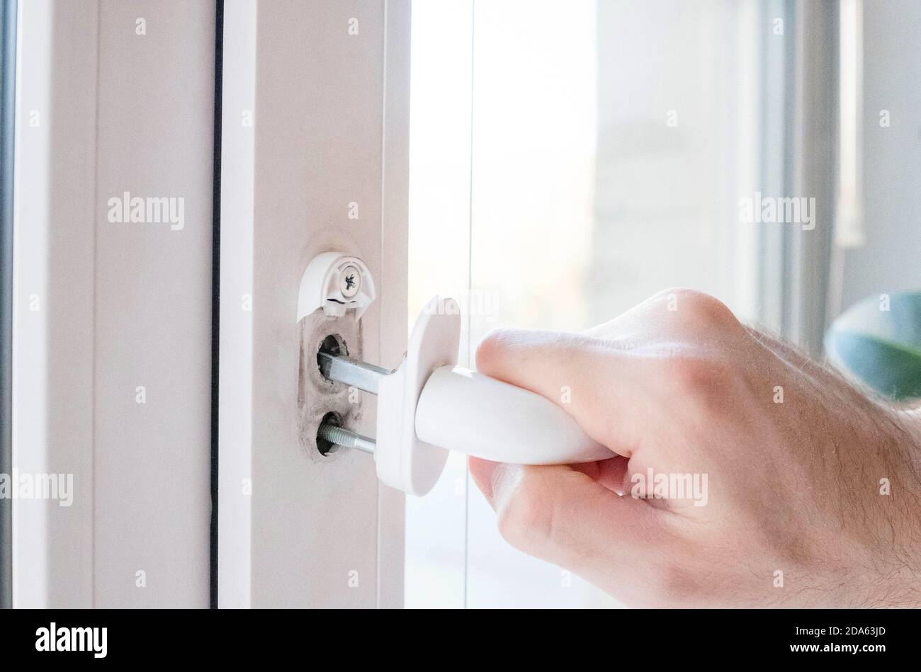 The window handle is broken. Hold the mechanism in hand Stock Photo - Alamy