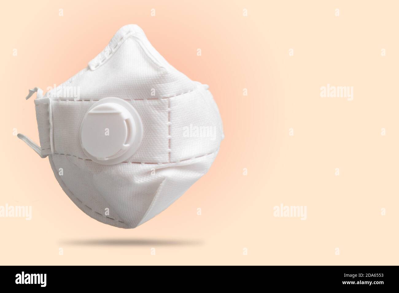 White n95 mask on pink background, n95 respirator with ventilation ...