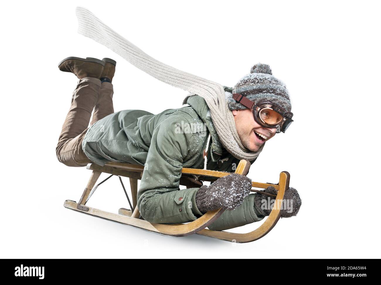 Smiling man riding a sled - isolated on white Stock Photo - Alamy