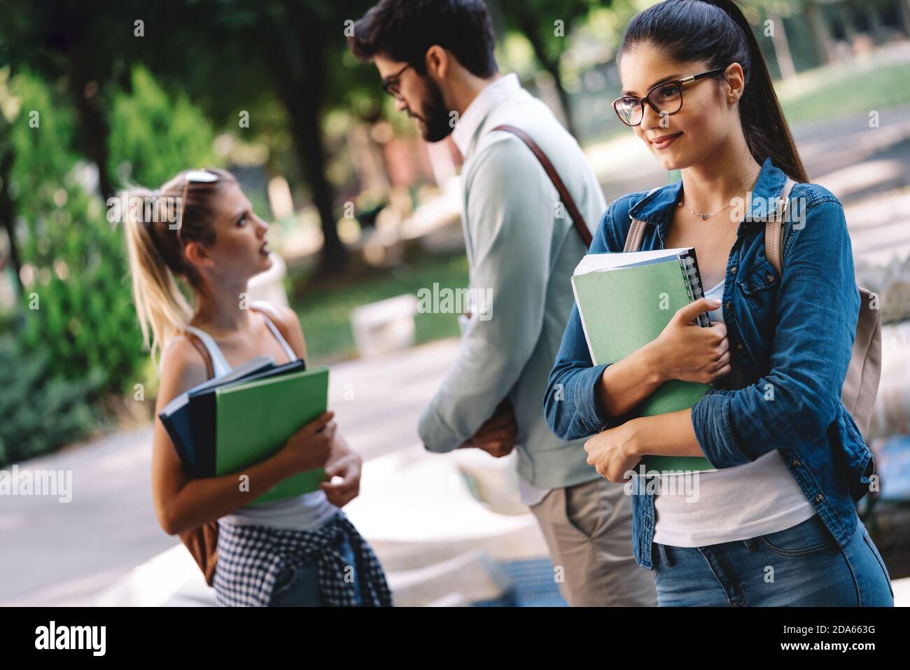 Group of friends, university students smiling, preparing for exam ...