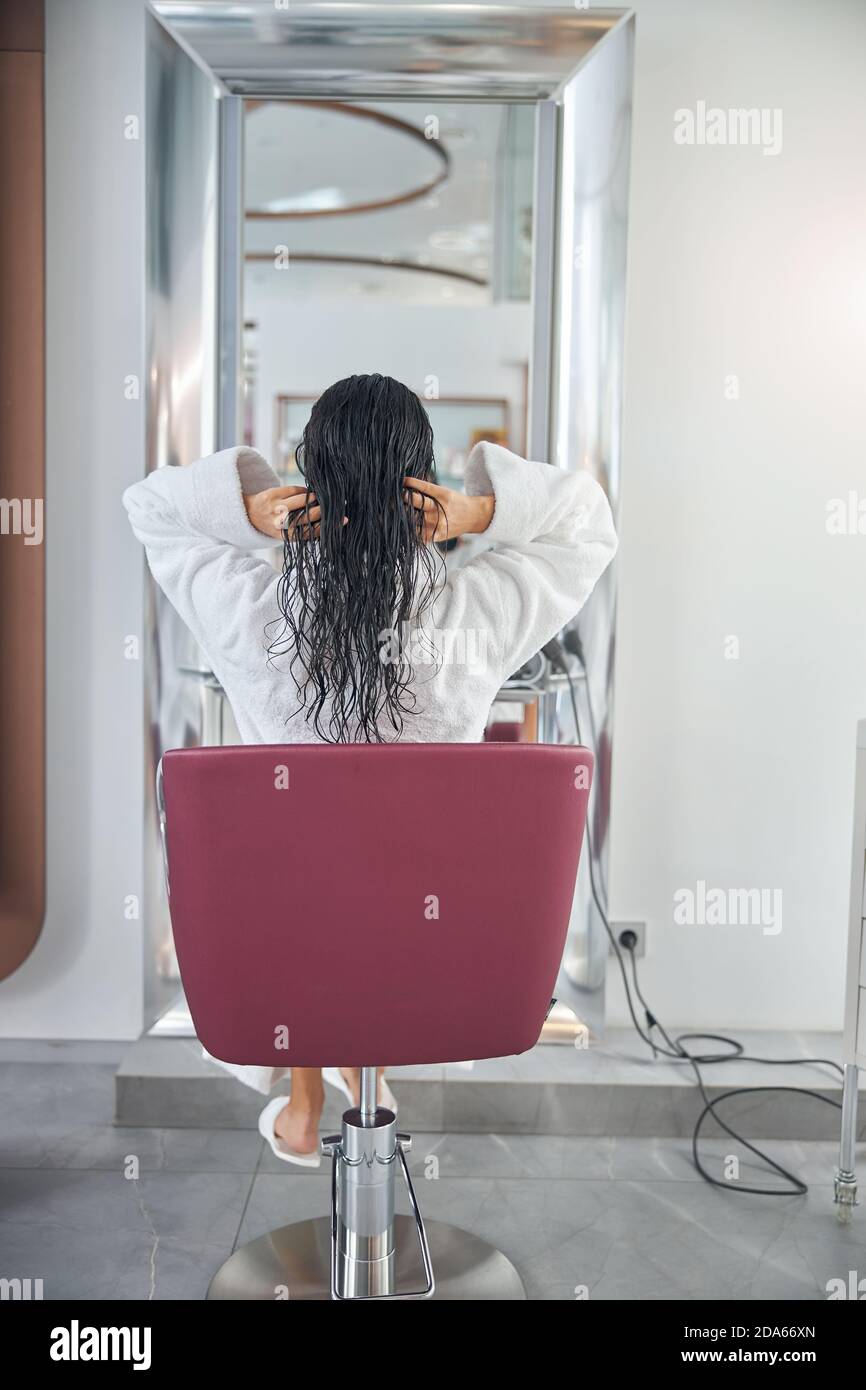 Back photo of a customer in a chair Stock Photo - Alamy