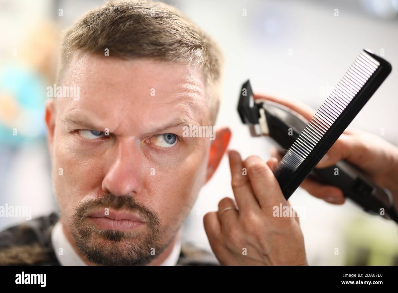 Portrait of pensive man who has haircut in hairdressing machine Stock ...