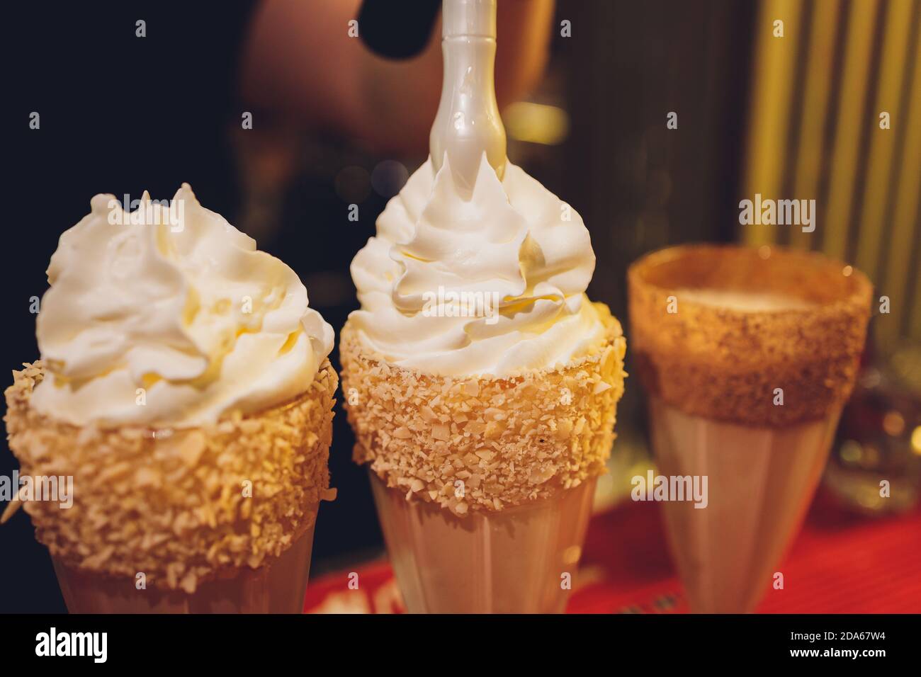 Glasses of milkshake, frappe, ice coffee and smoothie with whipped ...