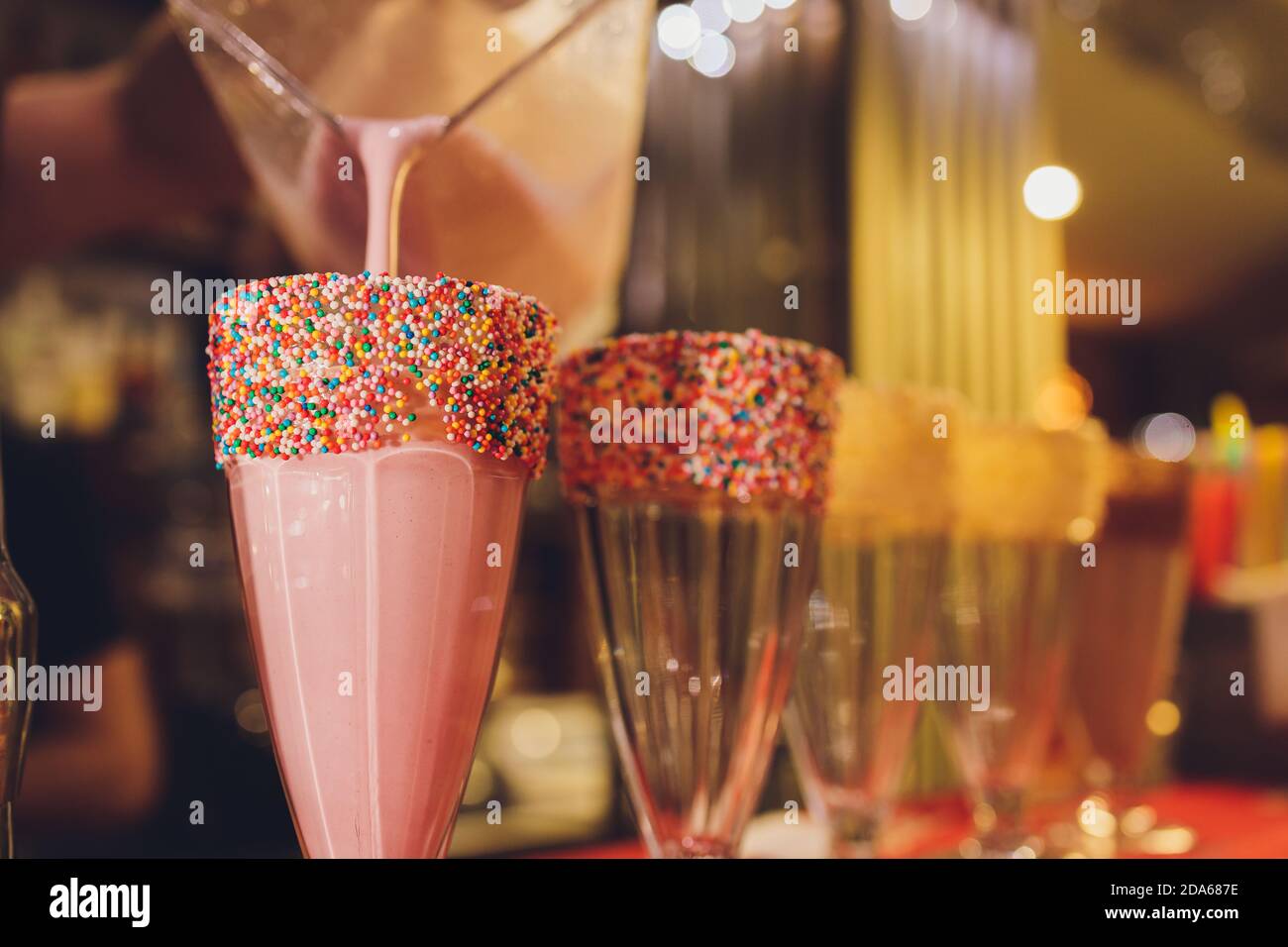 Glasses of milkshake, frappe, ice coffee and smoothie with whipped ...