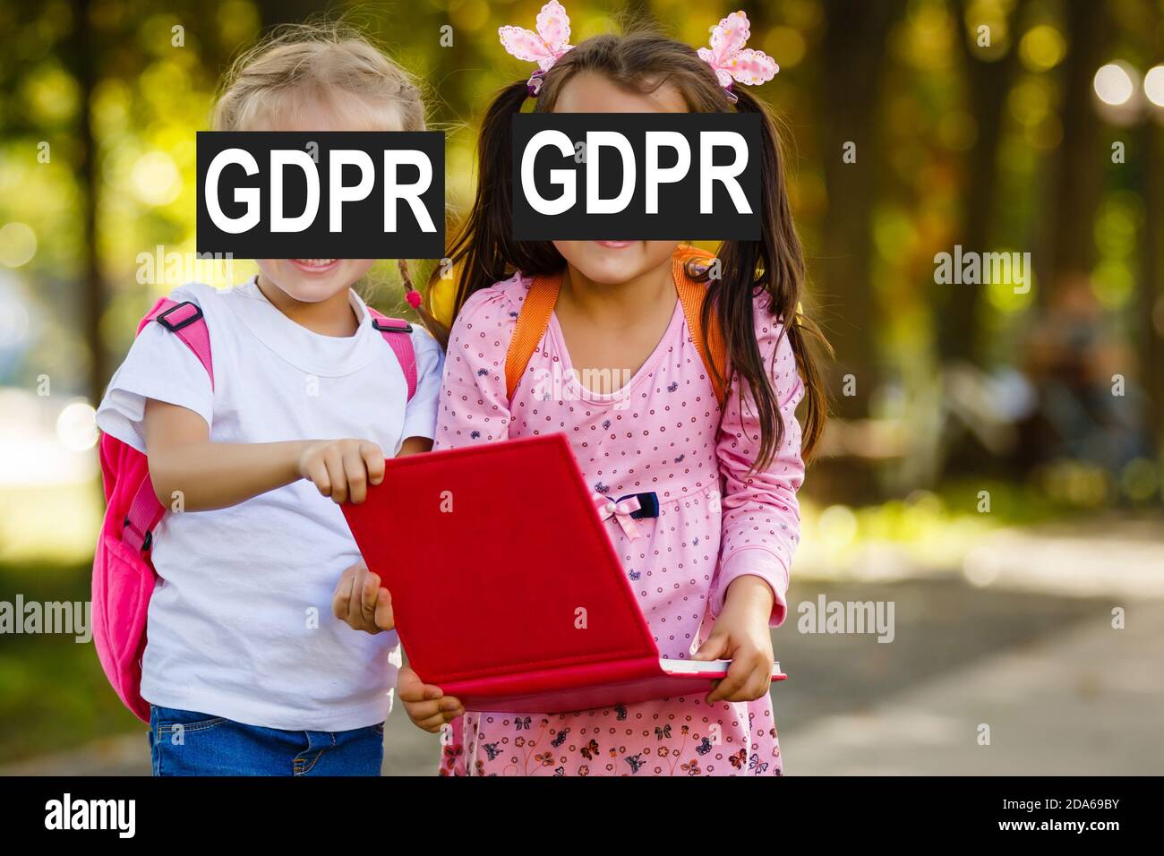 Portrait of the two cute little girls holding book. GDPR concept Stock ...