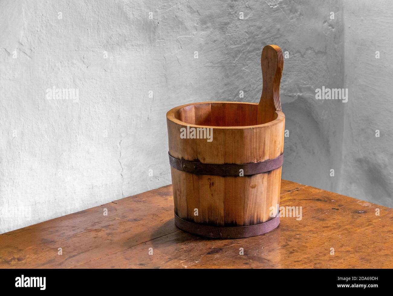 historic wooden bucket on wooden table Stock Photo - Alamy
