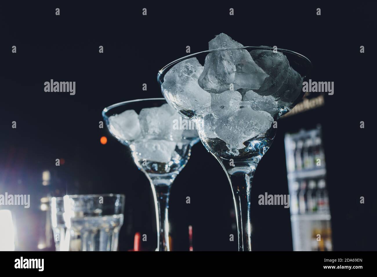 highball glass with ice and a yellow tube on the wooden bar Stock Photo - Alamy
