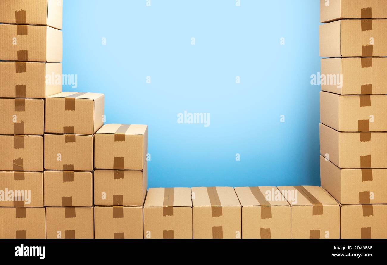 Cardboard boxes frame for delivery or moving. Stack of boxes and blue ...