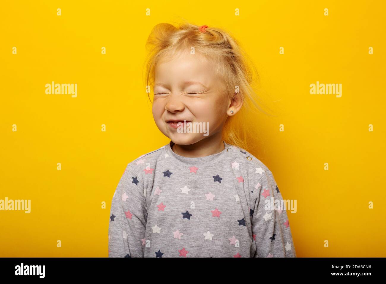 Little child with closed eyes on yellow background Stock Photo - Alamy