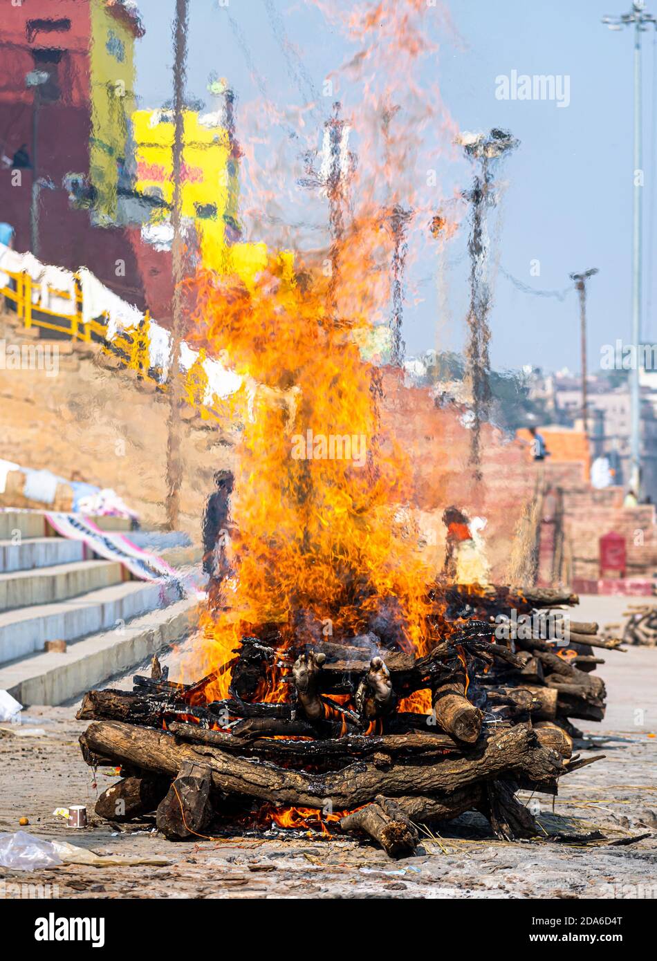 a pyre is burning on harishchandra ghat in banaras Stock Photo - Alamy