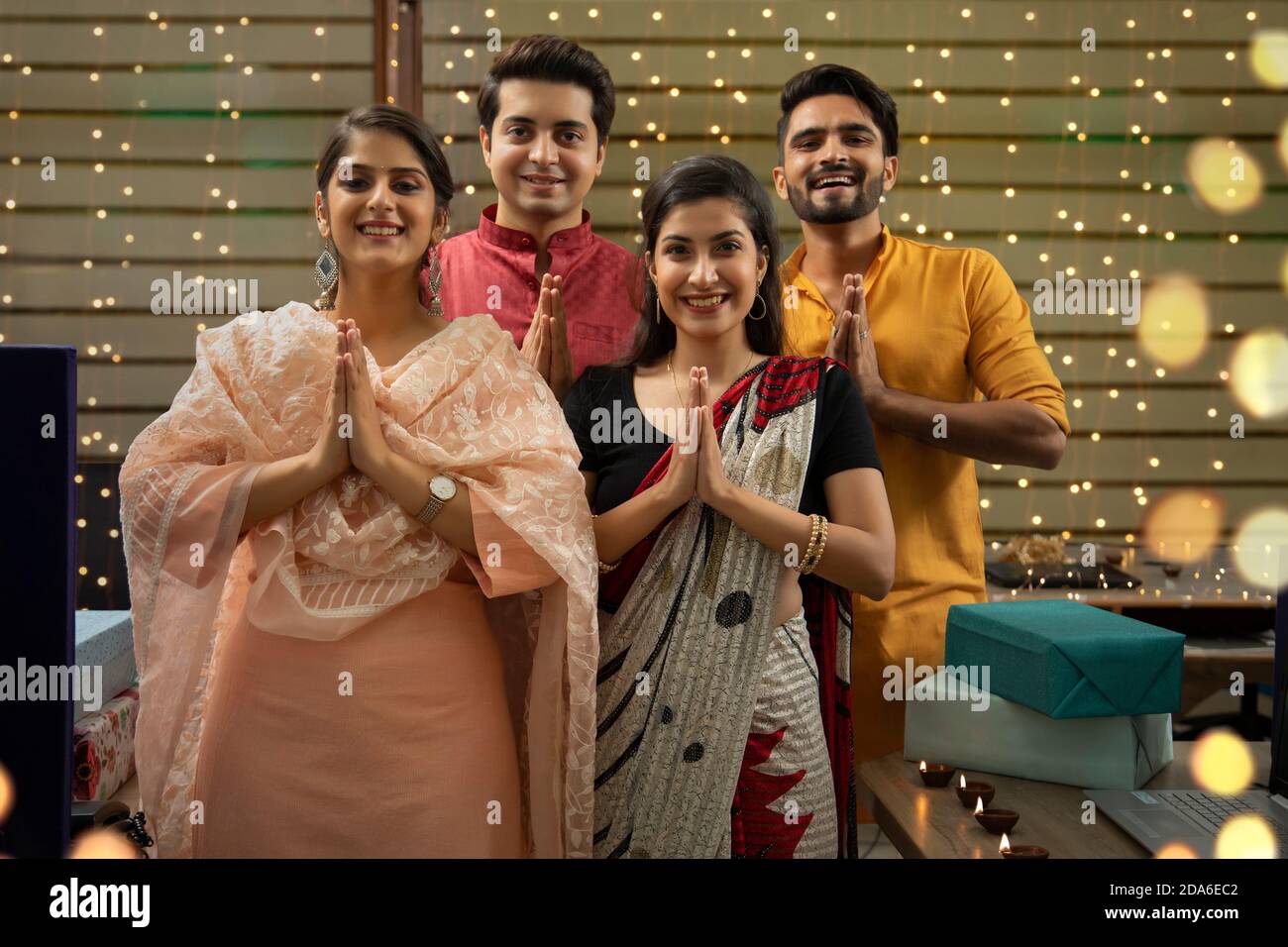 PORTRAIT OF A GROUP OF COLLEGUES HAPPILY GREETING OTHERS DURING DIWALI ...