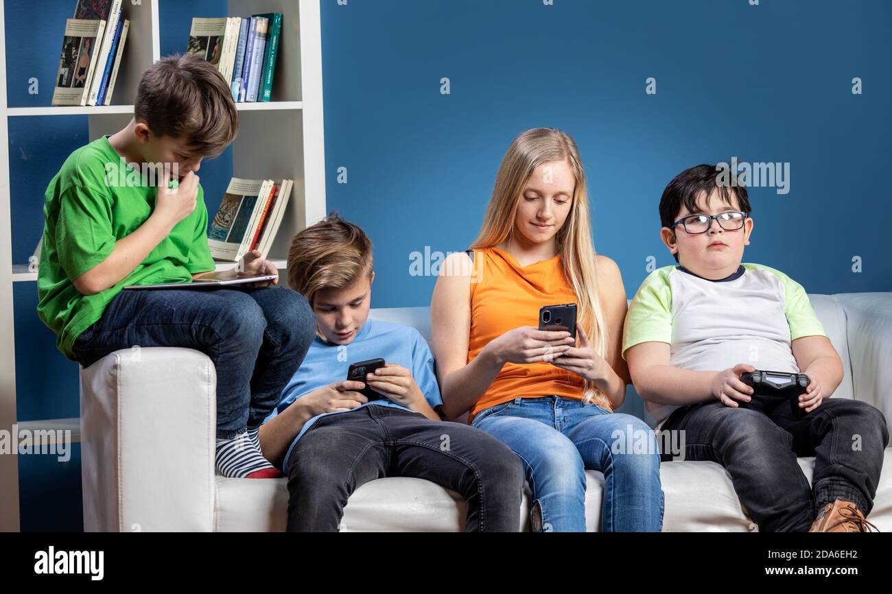 Teenager friends having fun, playing computer games, after all the ...