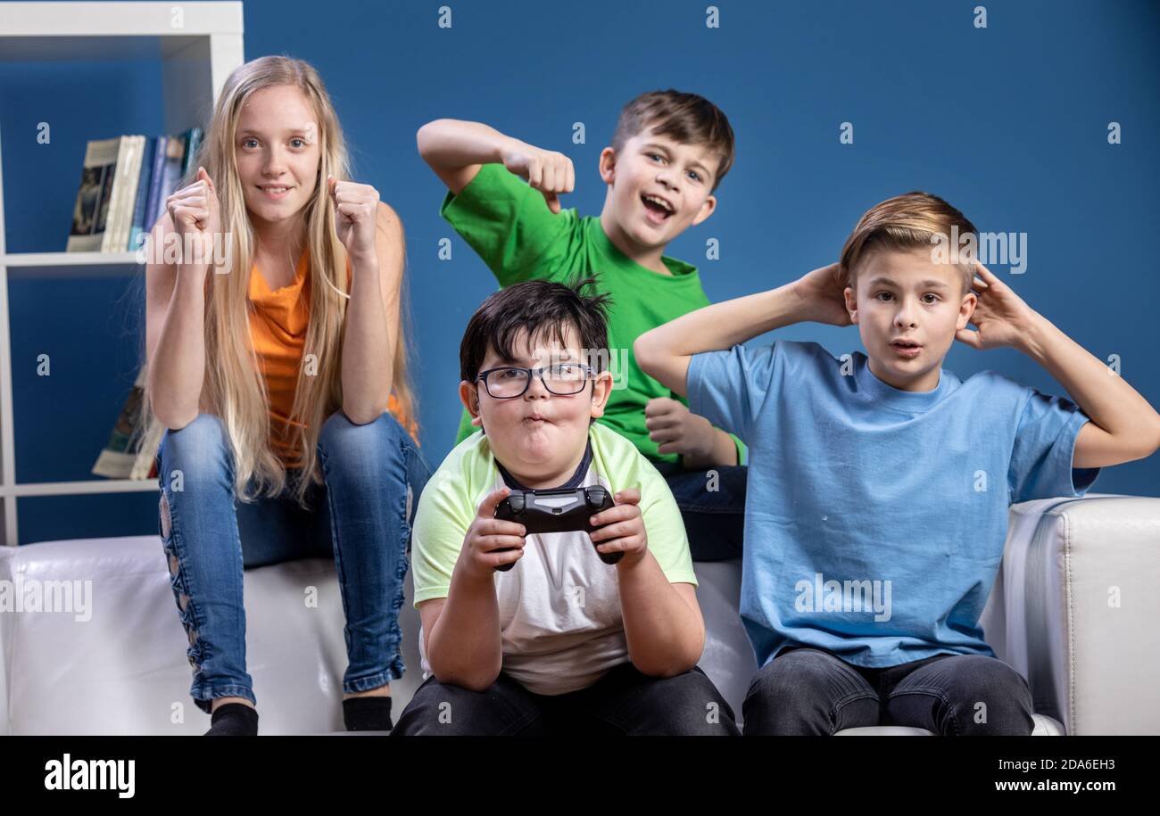 Teenager friends having fun, playing computer games, after all the ...