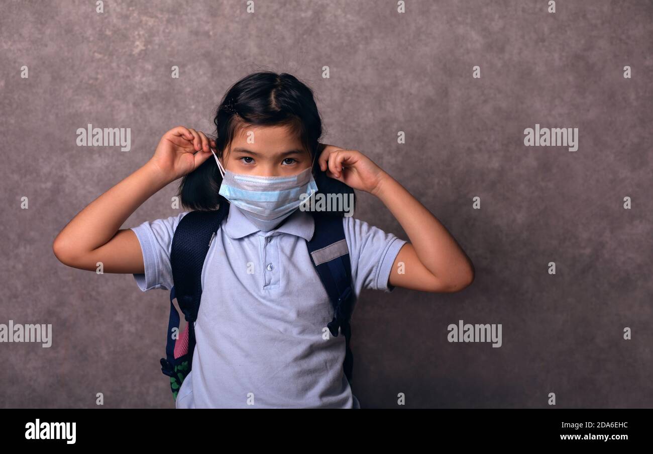 Elementary School Girl With Face Mask Going Back To School After Covid 