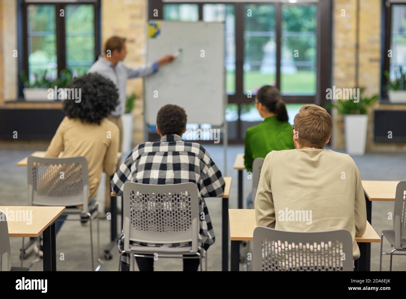 Never stop leaning at work. Confident mature coach or speaker pointing ...