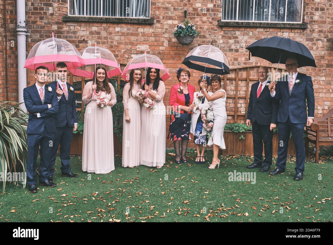 Wedding Group In The Rain Stock Photo - Alamy