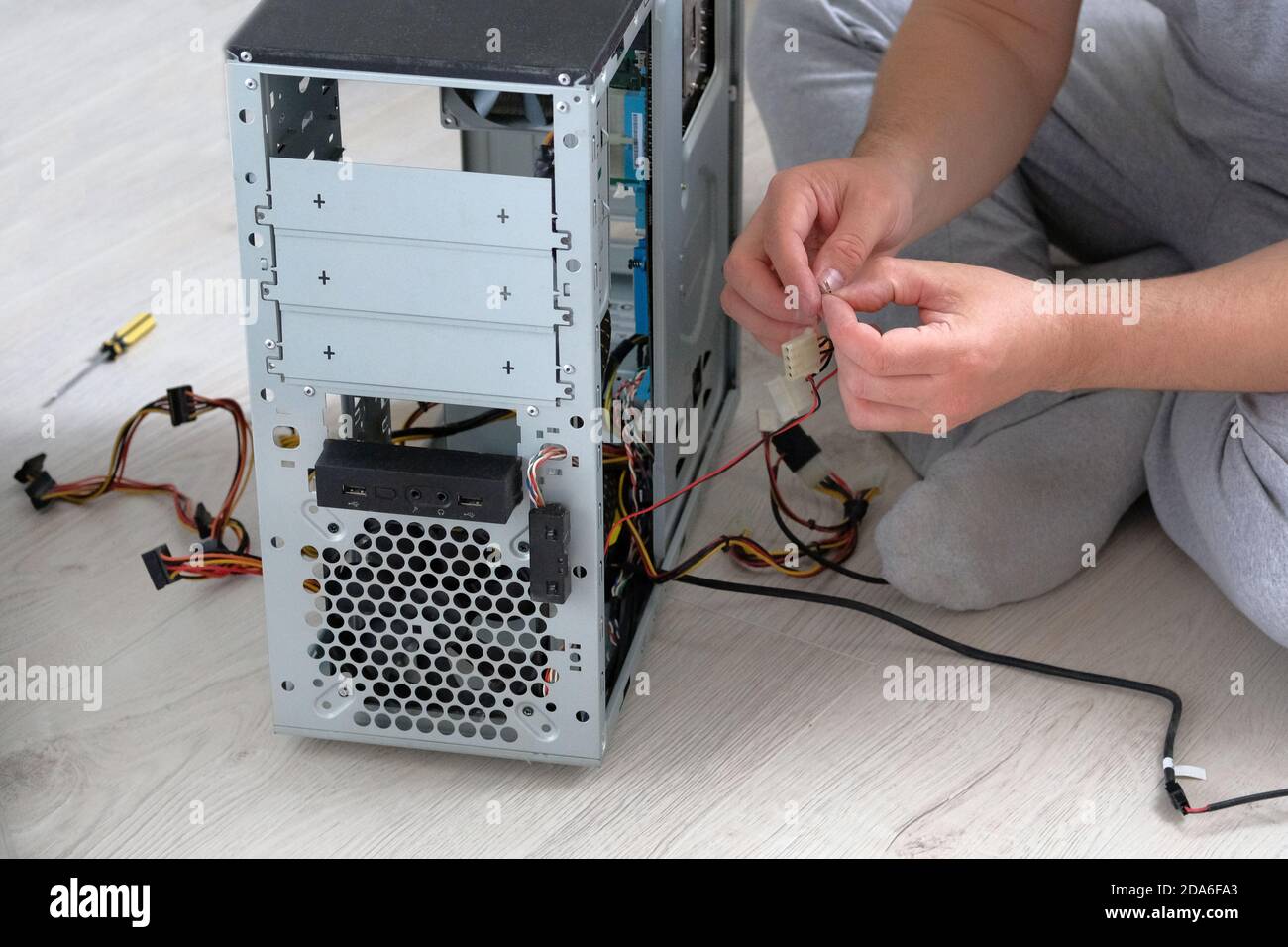 Service electronics and computers concept. Repairman is fixing computer ...