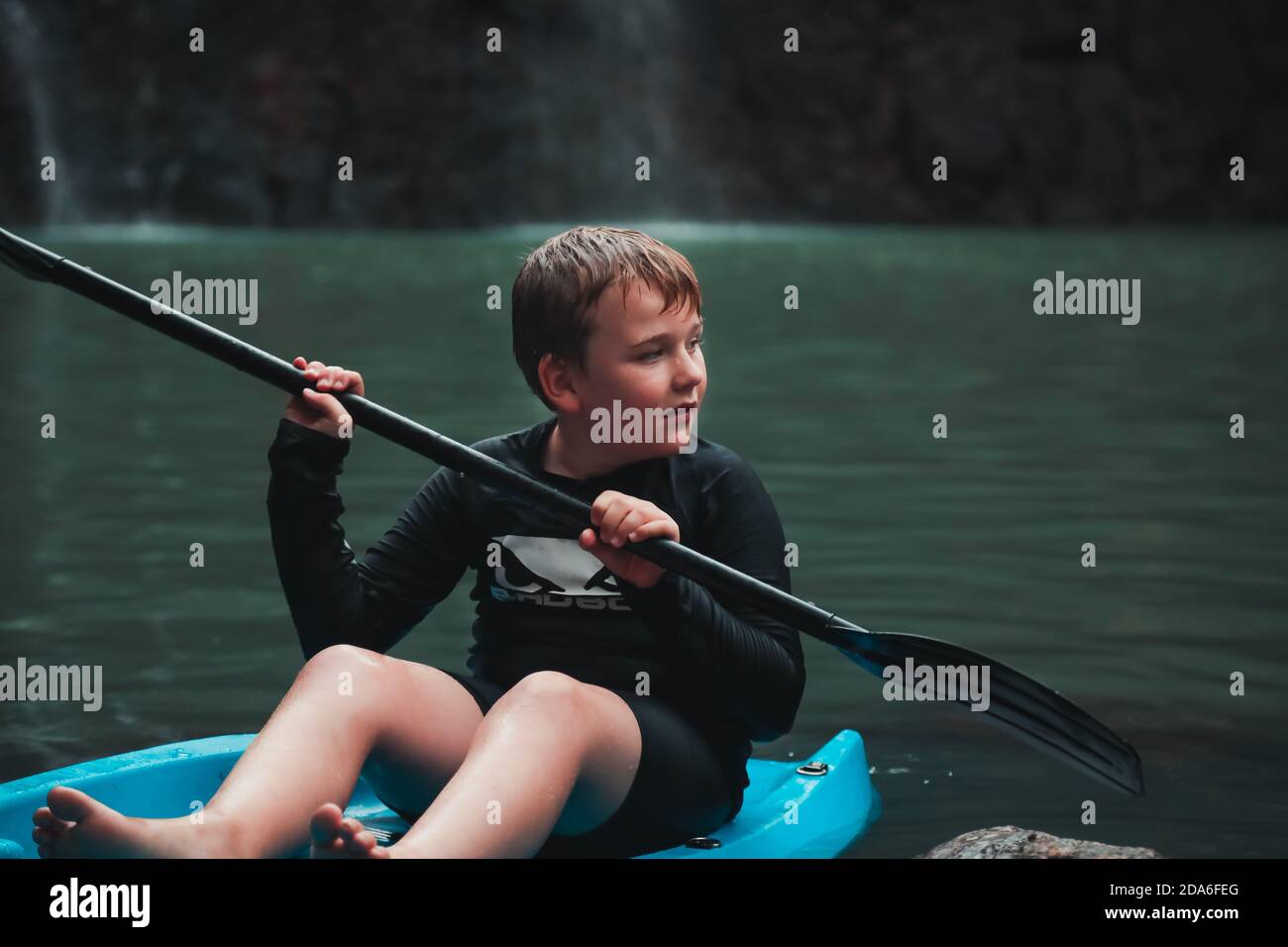 Young boy kayaking in the river Stock Photo - Alamy