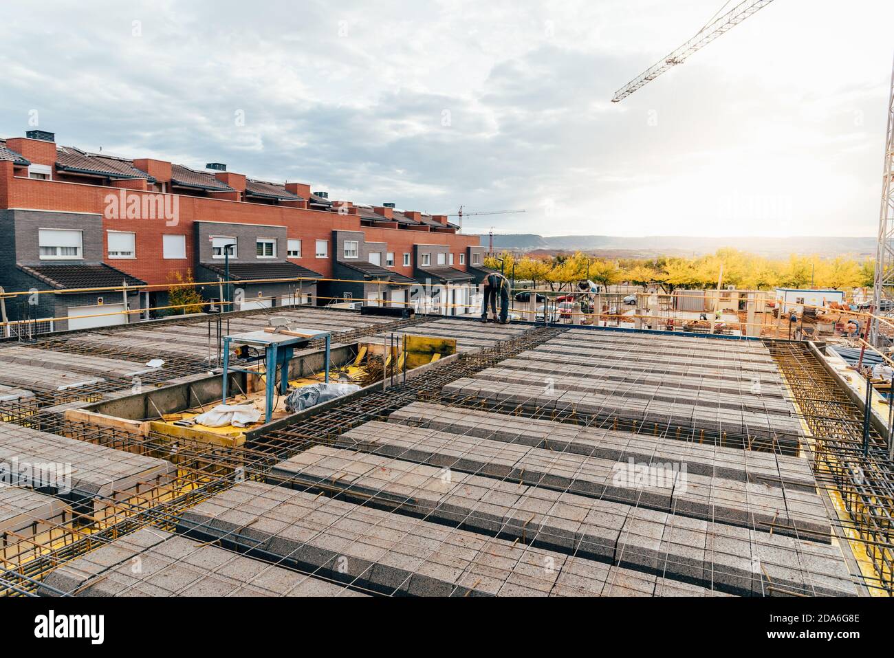 Construction worker working on a reinforced concrete slab at dawn Stock ...