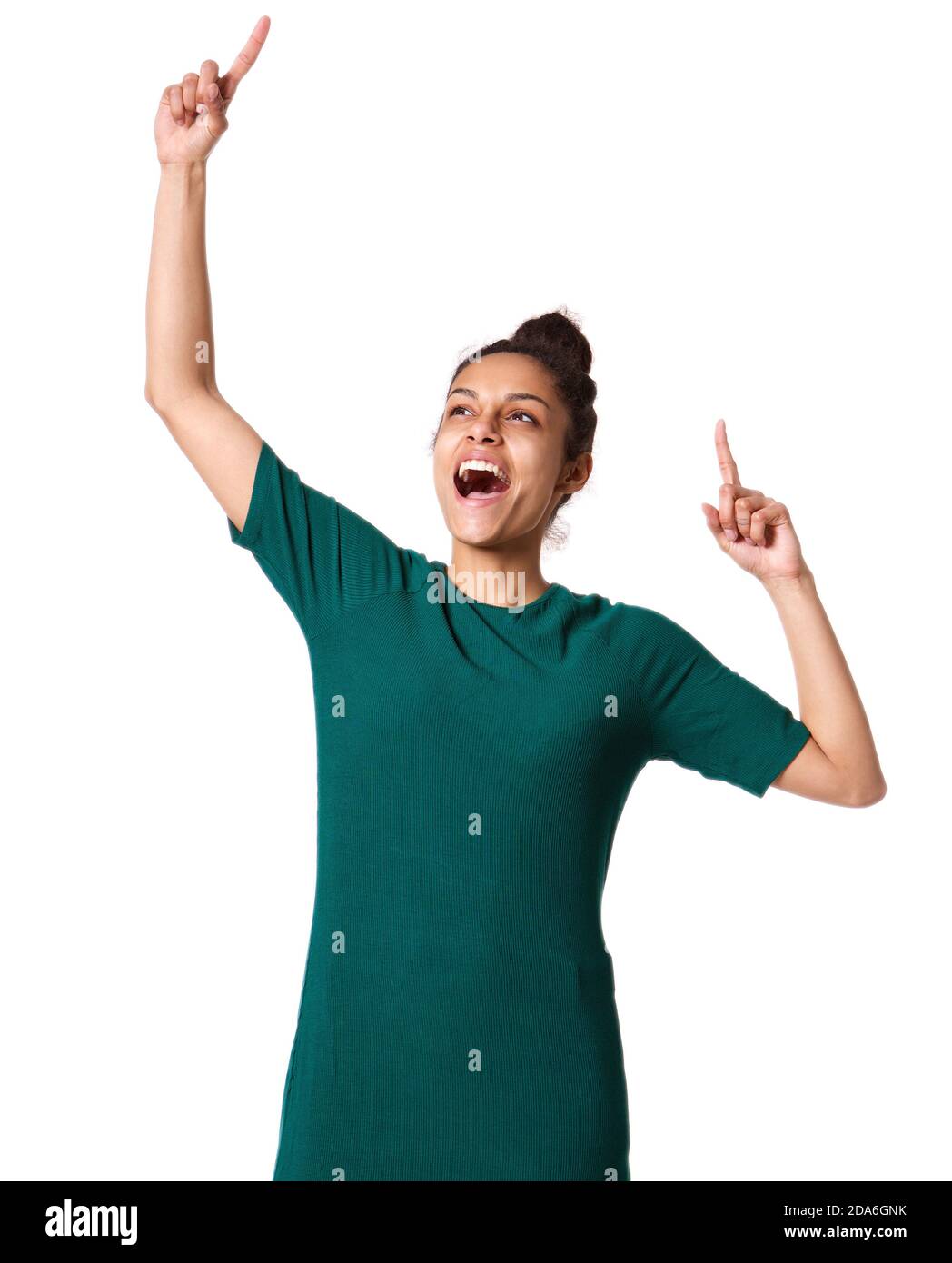 Portrait of excited young woman with hands raised in celebration over ...