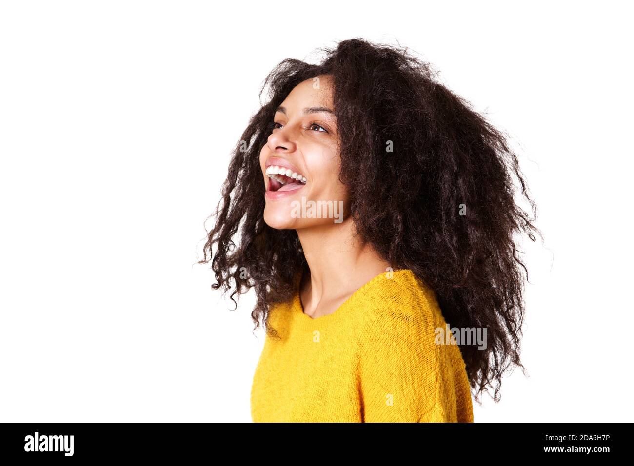 Close up side portrait of beautiful young woman laughing on white ...
