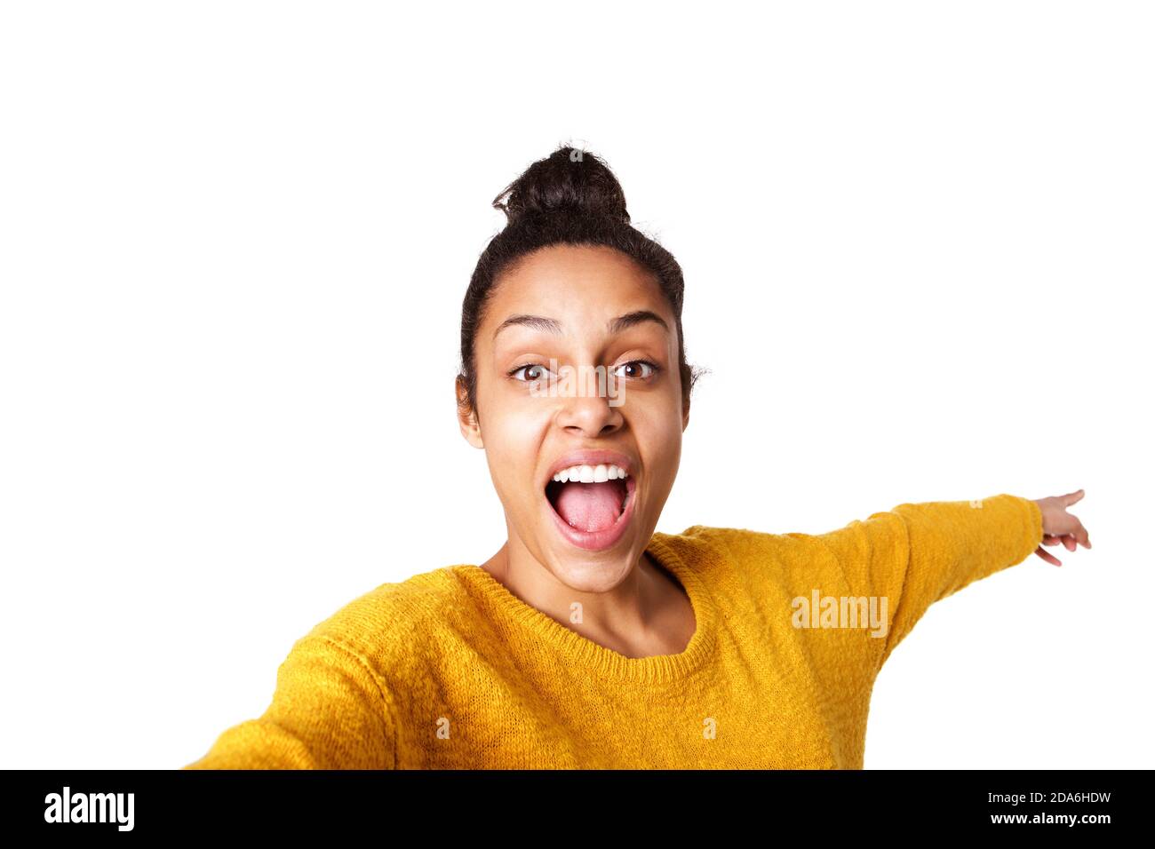 Close up portrait of excited young african woman pointing back and ...