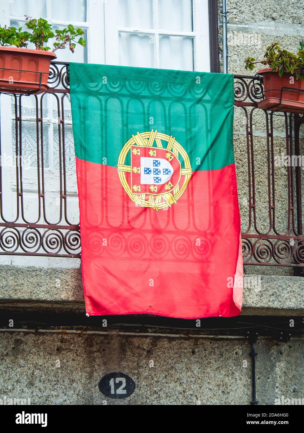 Portuguese flag hanging on a balcony in Porto, Portugal Stock Photo - Alamy