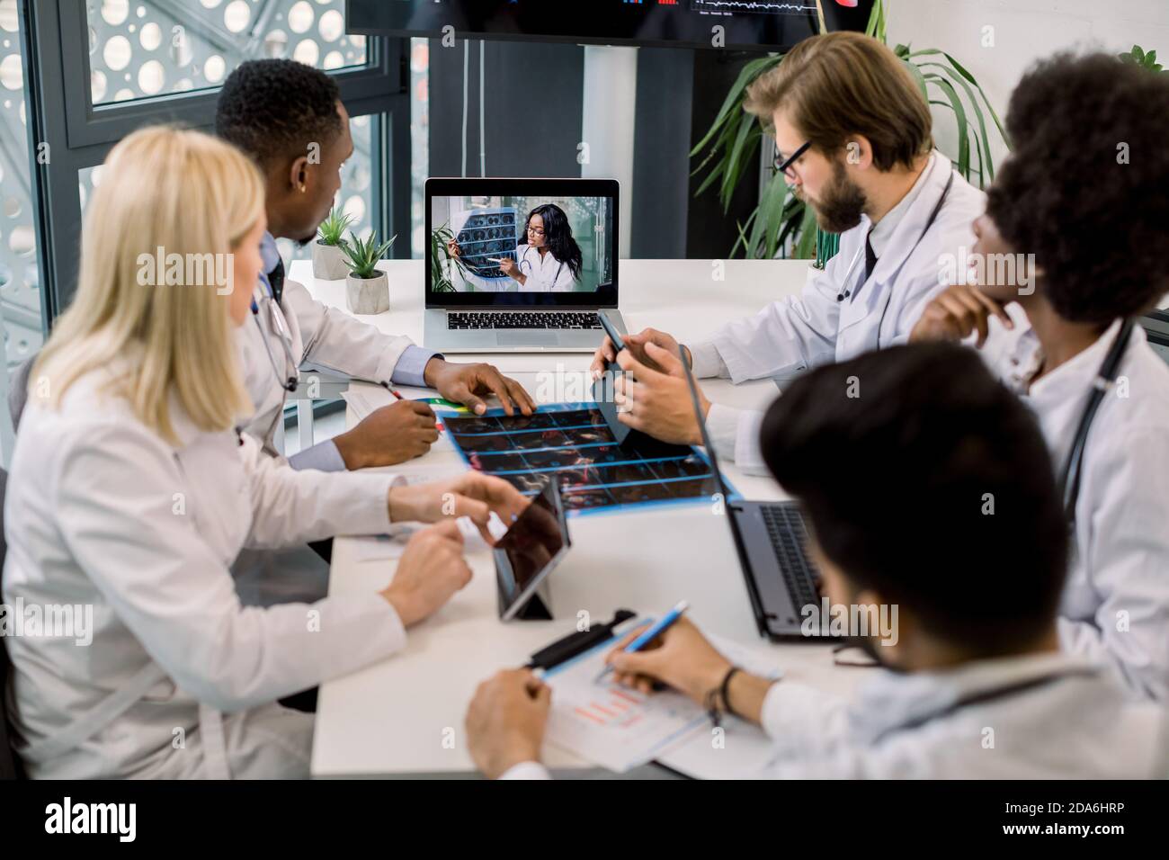 Team of multiracial experienced doctors or scientists, having video ...