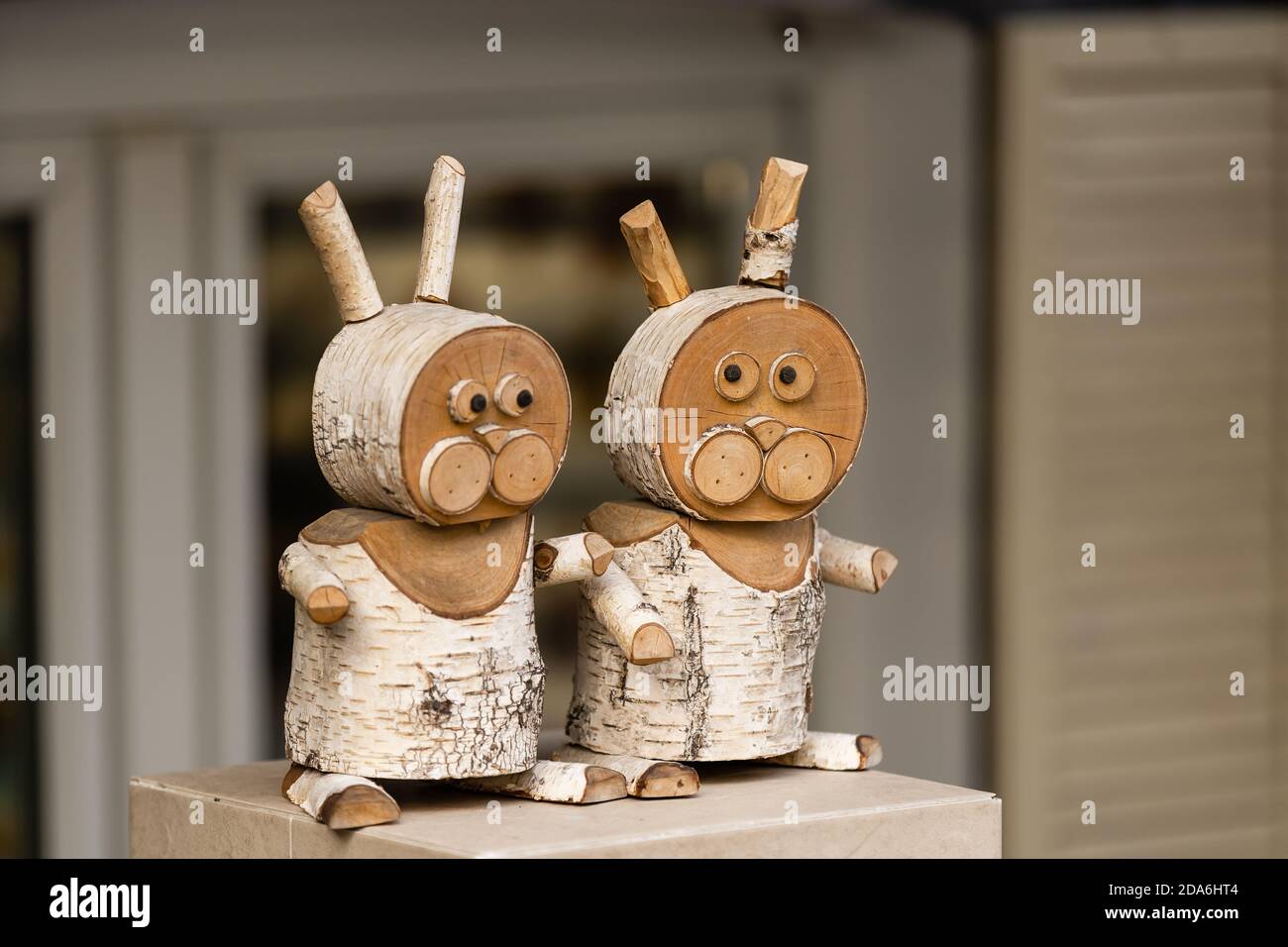 At the front door of the house there are three wooden rabbits Stock ...