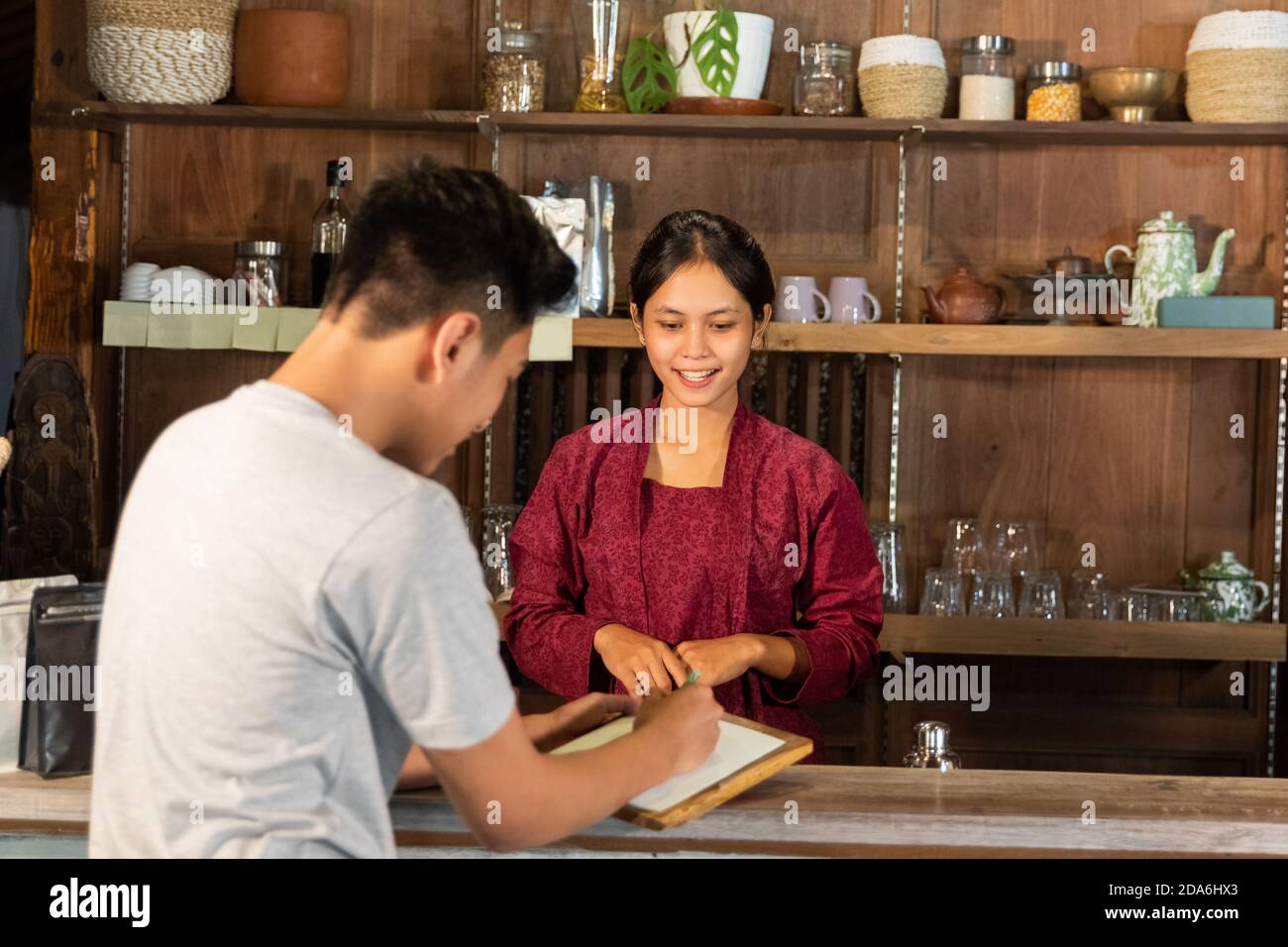 young man write the menu to be ordered Stock Photo - Alamy
