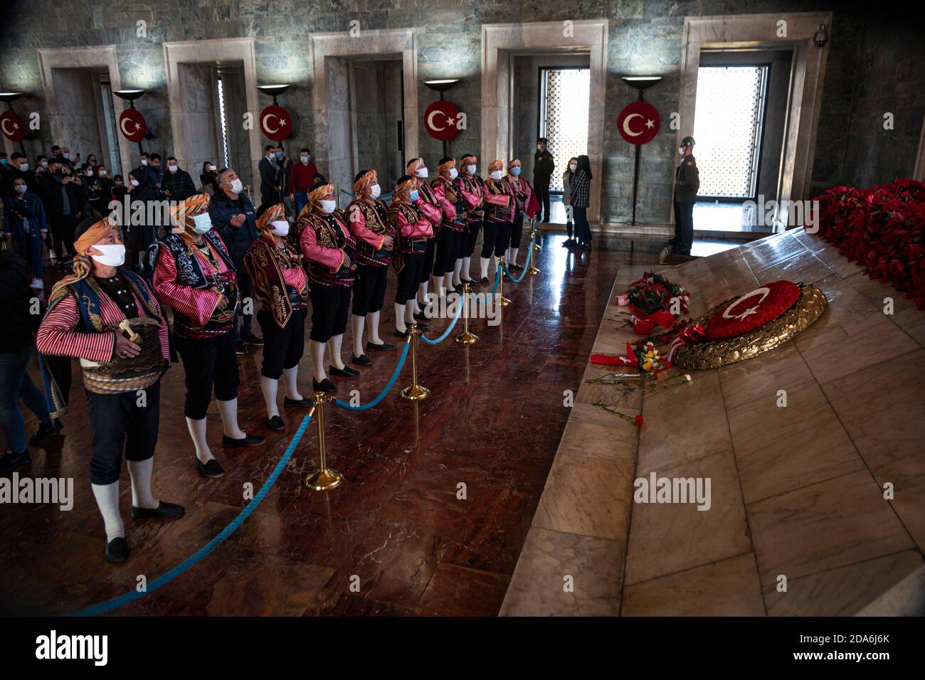 The traditional folk dance team is seen wearing facemasks as they await ...