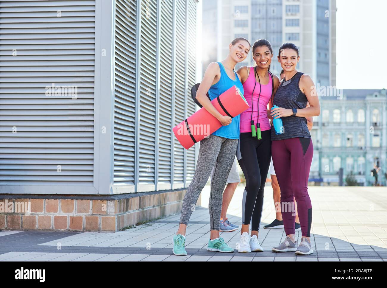 Beautiful young sportive girls holding fitness equipment Stock Photo ...