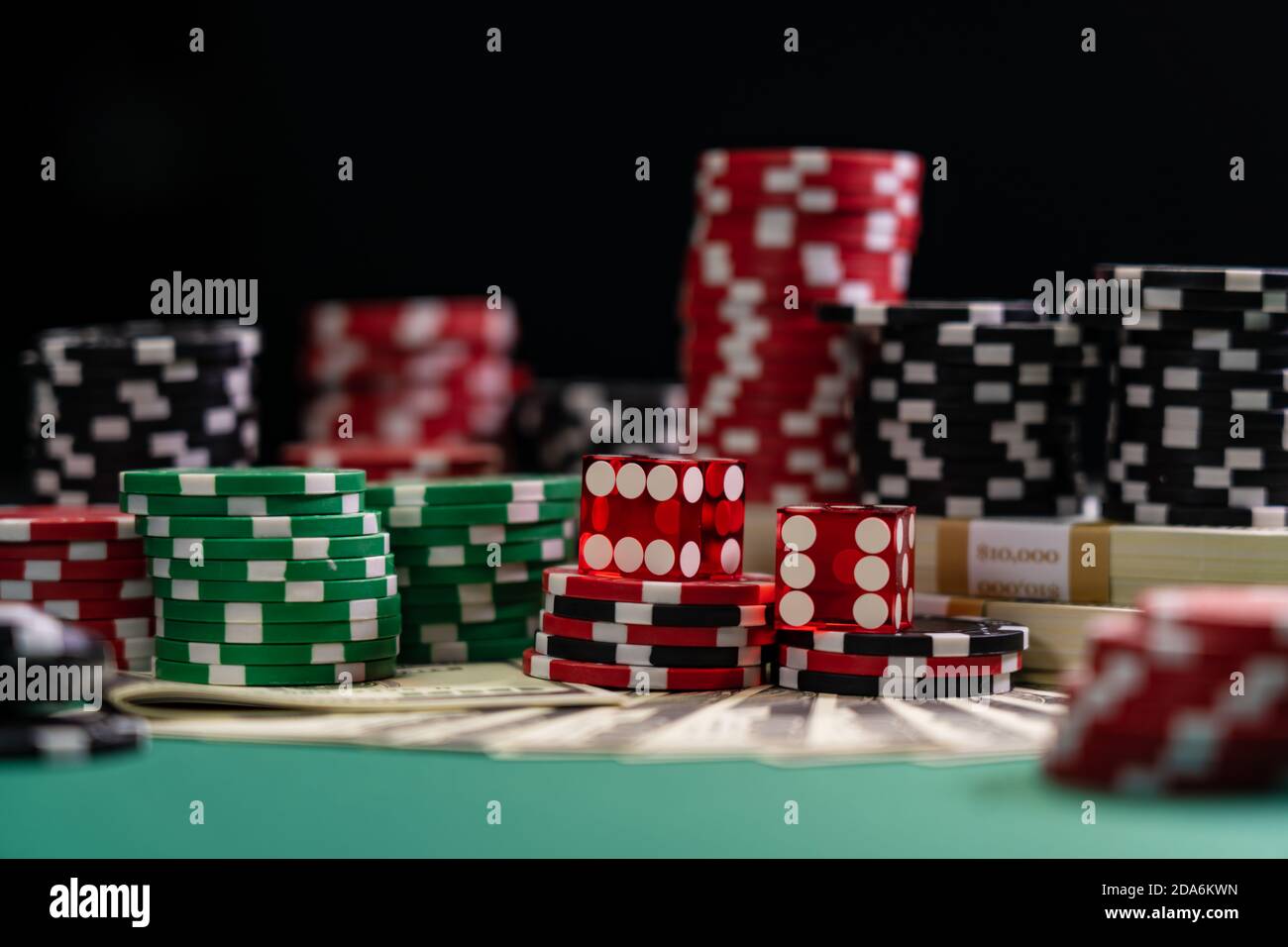 Casino red Craps dice with USD 100 bills - Shallow depth of field Stock ...