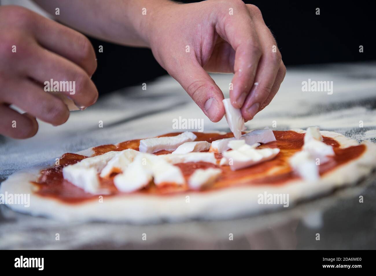 detail of the hands of a pizza chef chef who works for the various ...
