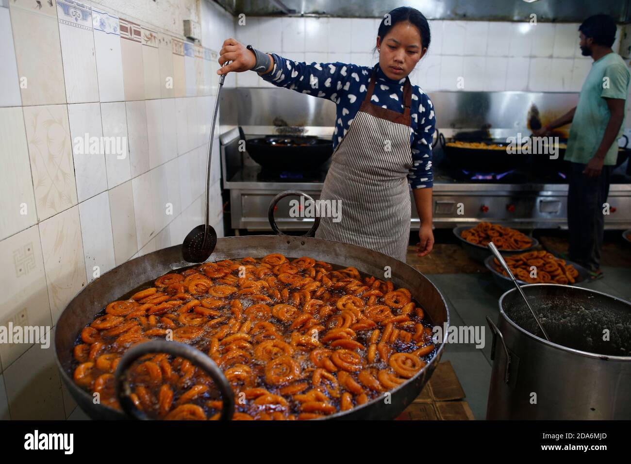 Kathmandu, Nepal. 10th Nov, 2020. A confectioner cooks traditional ...