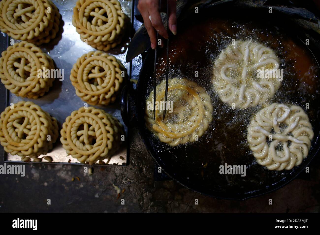 Kathmandu, Nepal. 10th Nov, 2020. A confectioner cooks traditional ...