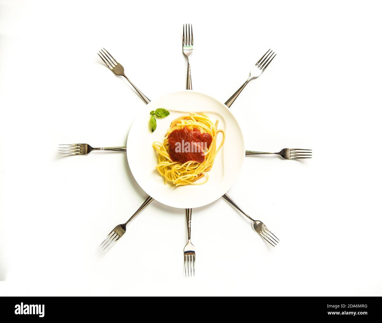 creative spaghetti on the plate with the forks forming the hands of a ...
