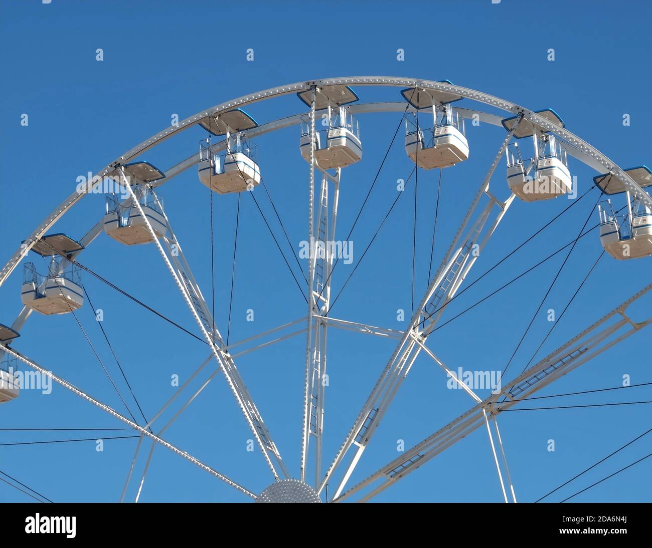 Empty white ferris wheel in front of blue sky Stock Photo - Alamy