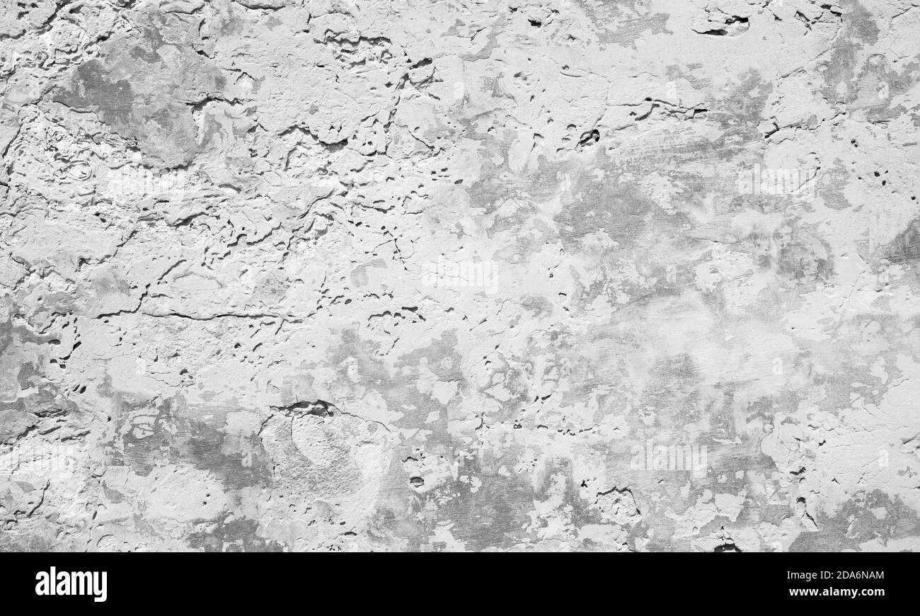Old grungy concrete wall texture with damaged white paint layer, front ...