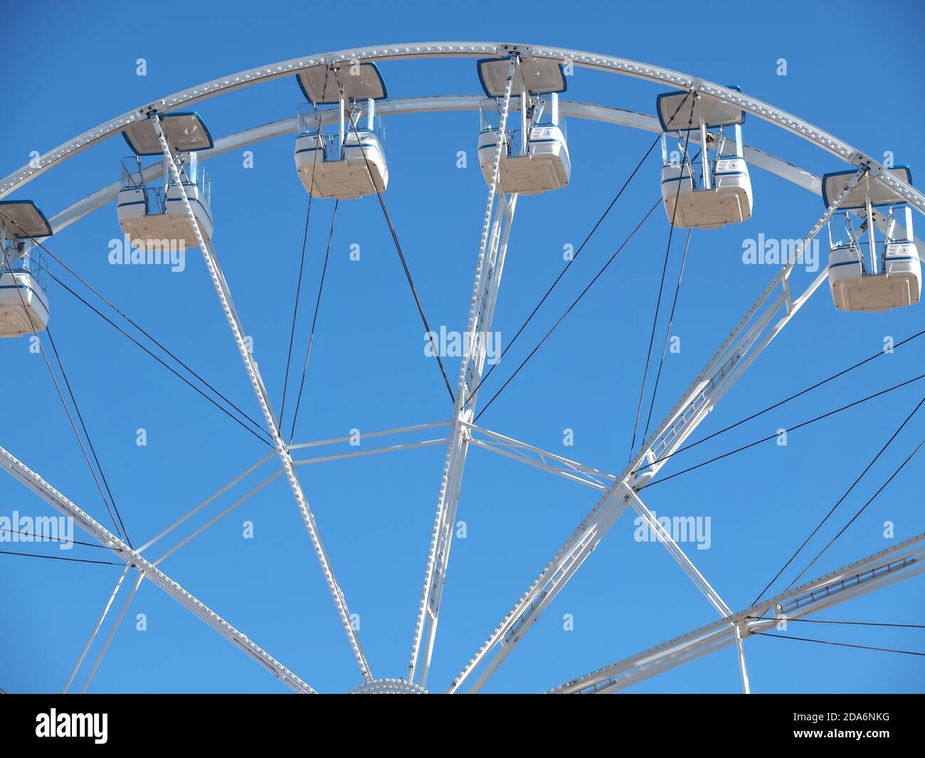 Empty white ferris wheel in front of blue sky Stock Photo - Alamy