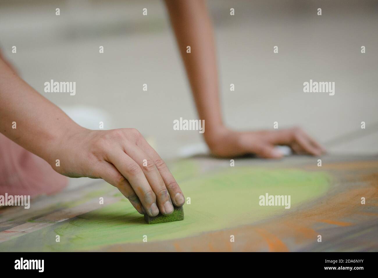 Girl drawing with chalk Stock Photo - Alamy