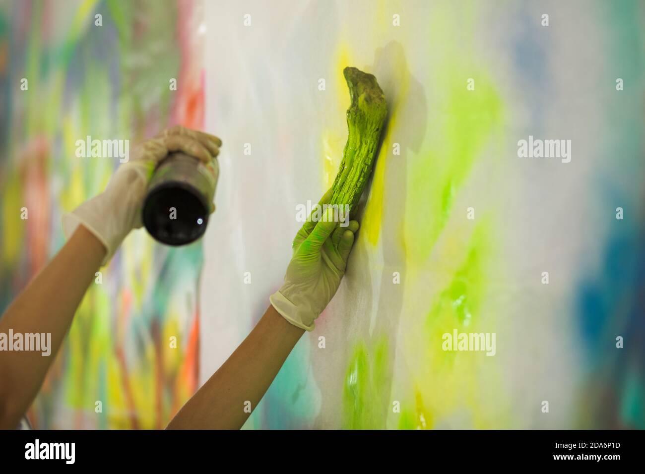 Making a painting: hands spraying color over objects Stock Photo - Alamy