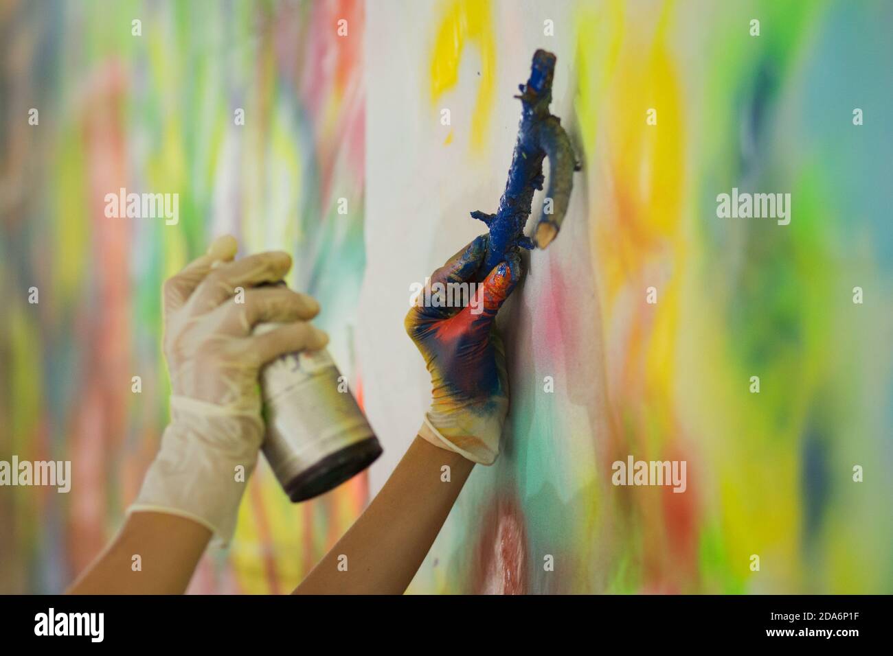 Making a painting: hands spraying color over objects Stock Photo - Alamy