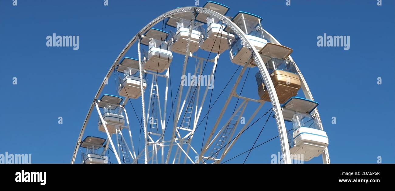 Empty white ferris wheel in front of blue sky Stock Photo - Alamy