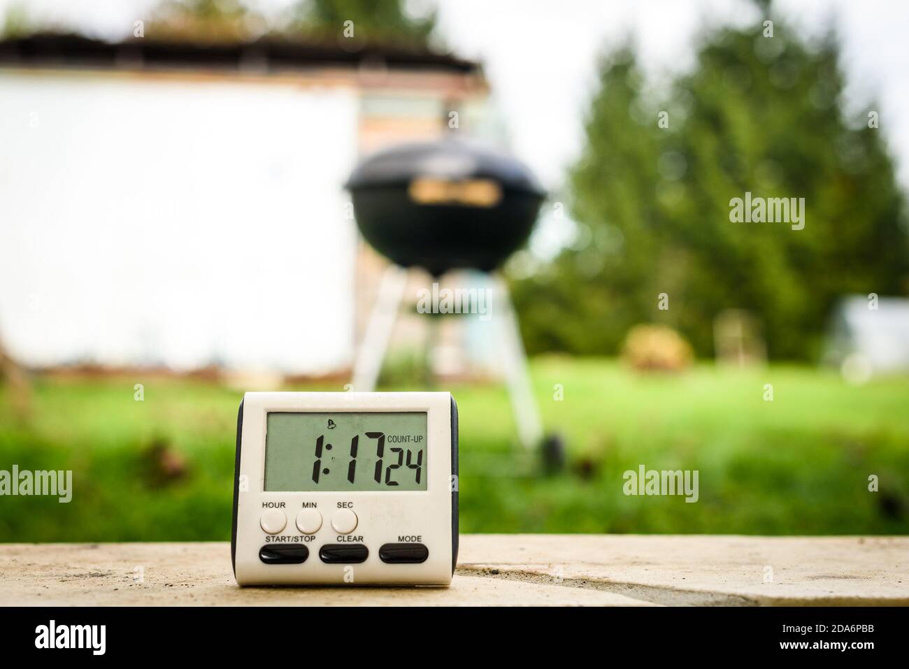 Digital cooking counter with barbecue grill in background. Counting ...