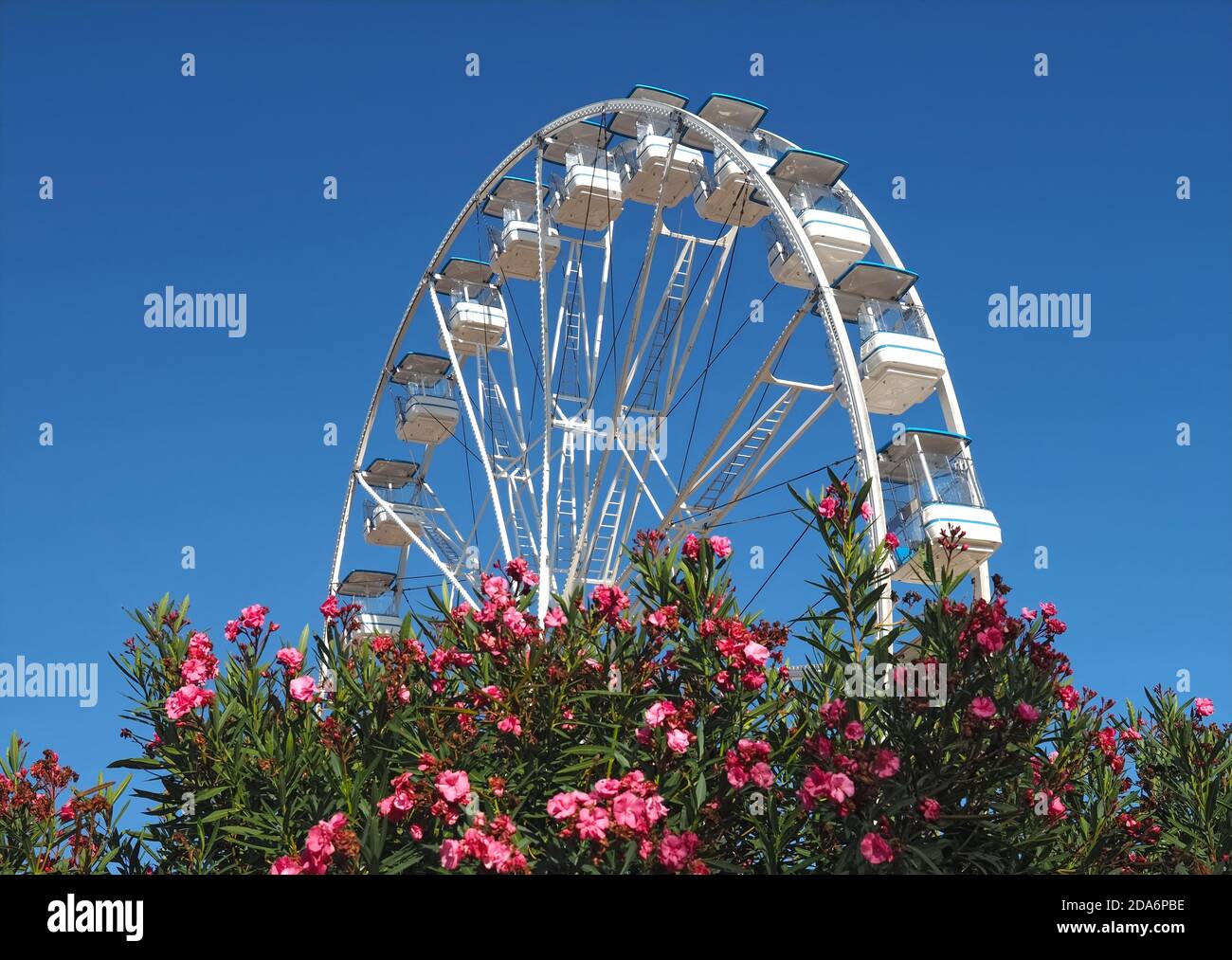 Empty white ferris wheel in front of blue sky Stock Photo - Alamy