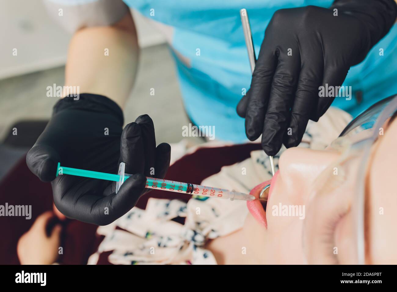 Dentist giving injection for anesthetizing his patient Stock Photo - Alamy