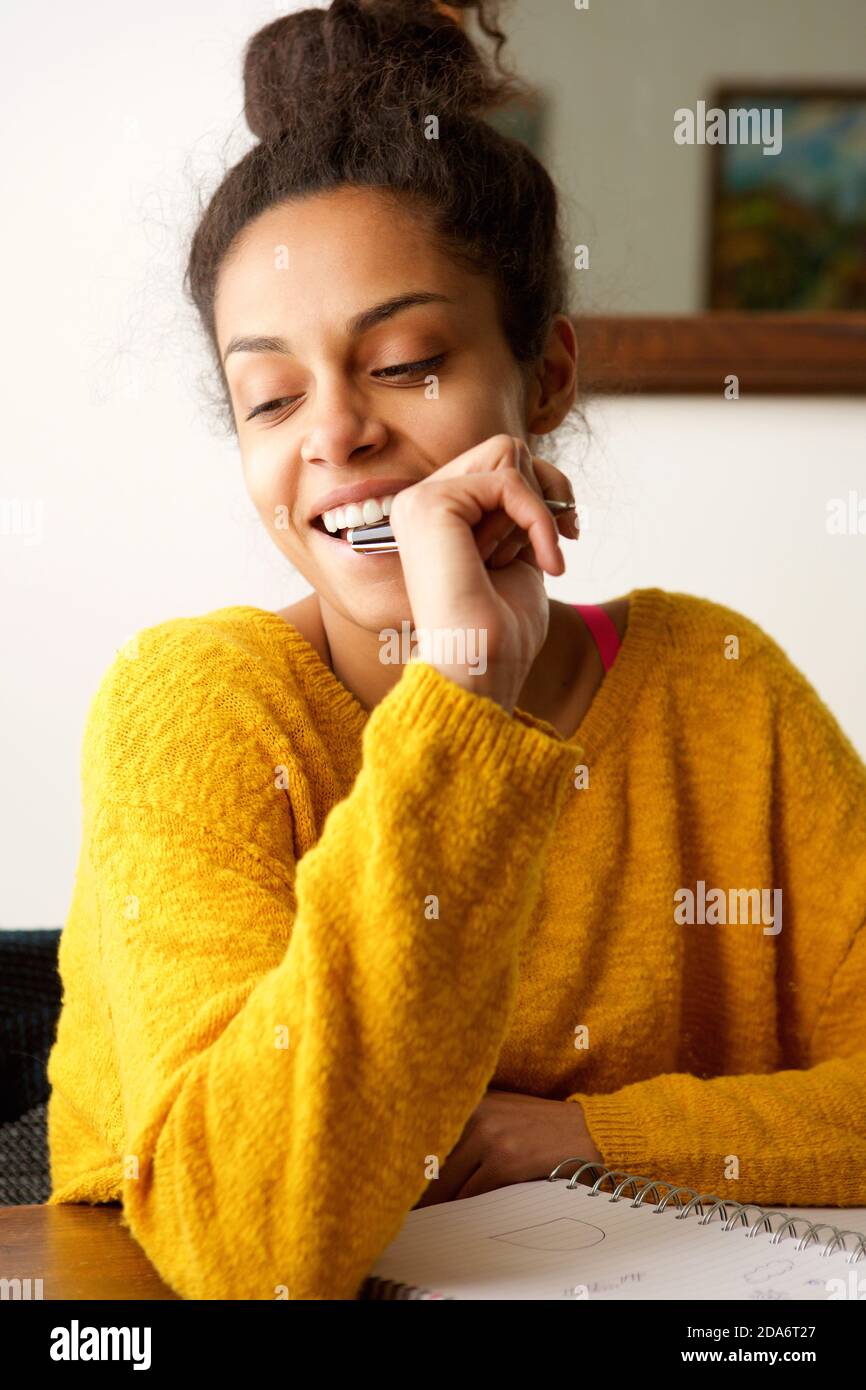 Portrait of young female student with pen and notebook Stock Photo - Alamy